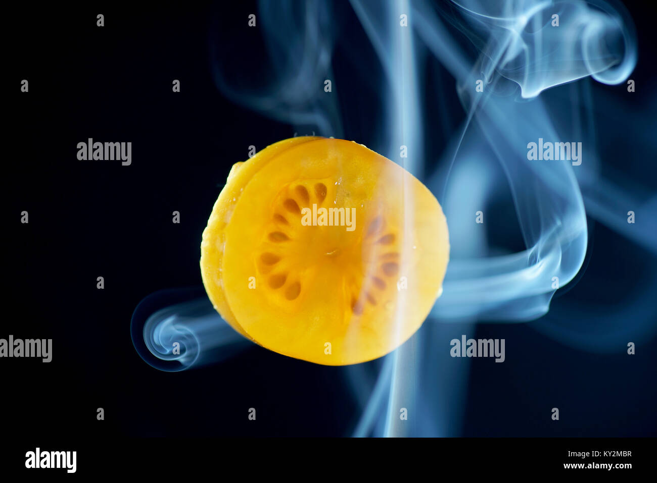 A tomato sliced and photographed in front of flash in the studio Stock ...