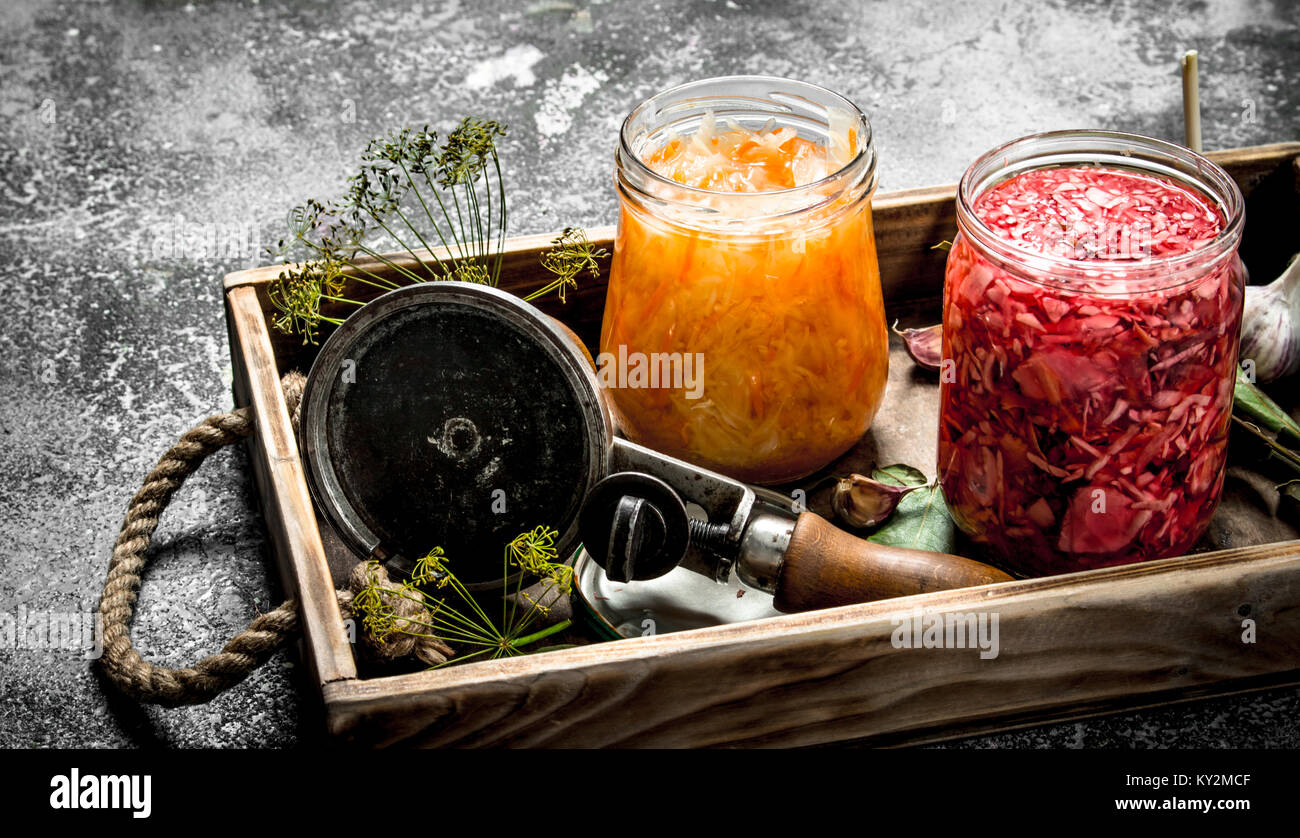 Marinated cabbage with herbs and seamer on a tray. On a rustic ...