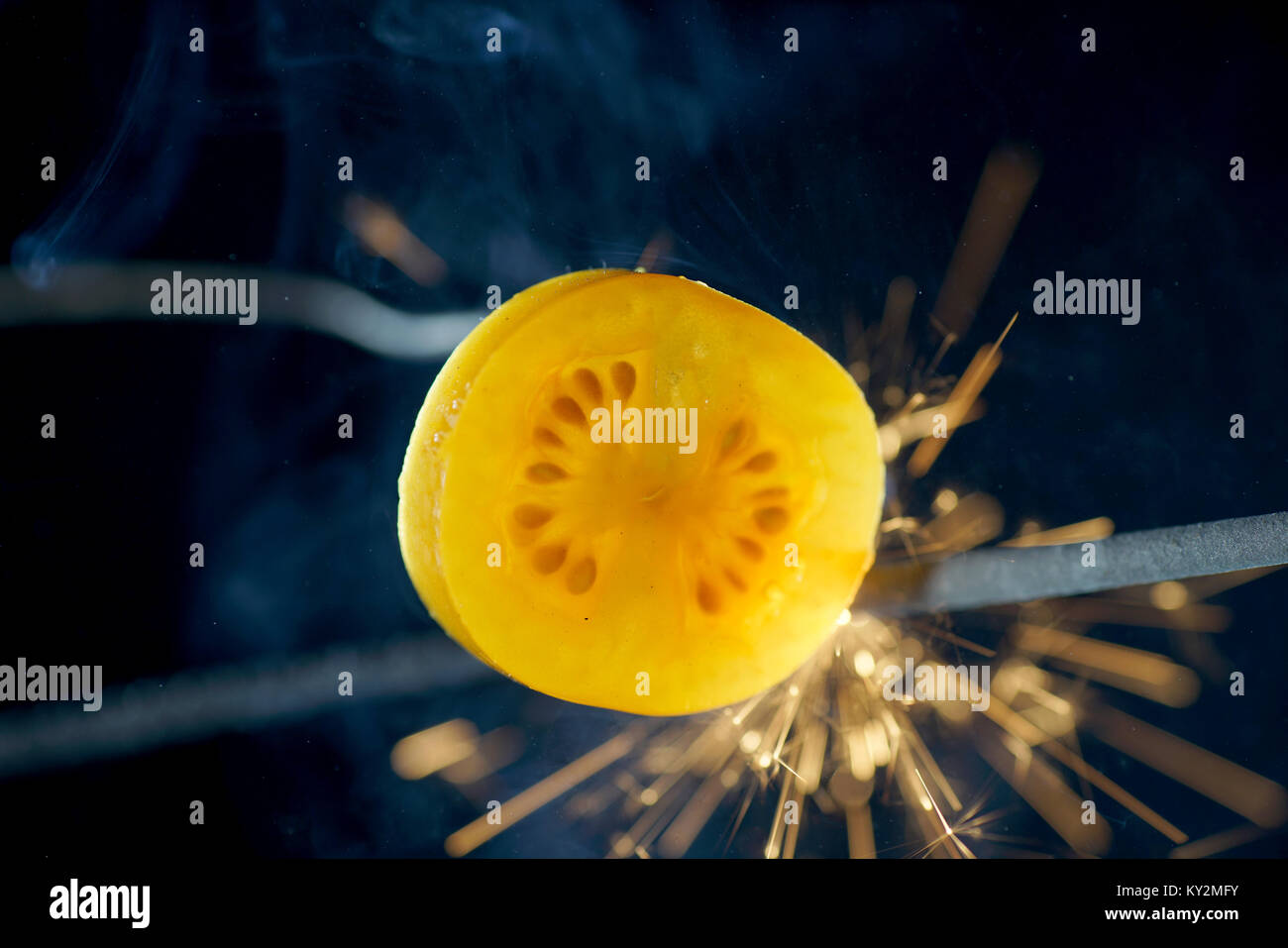 A tomato sliced and photographed in front of flash in the studio Stock ...