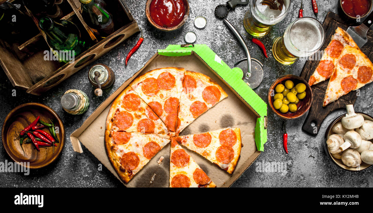 Pizza background. Pepperoni with beer. On a rustic background Stock ...