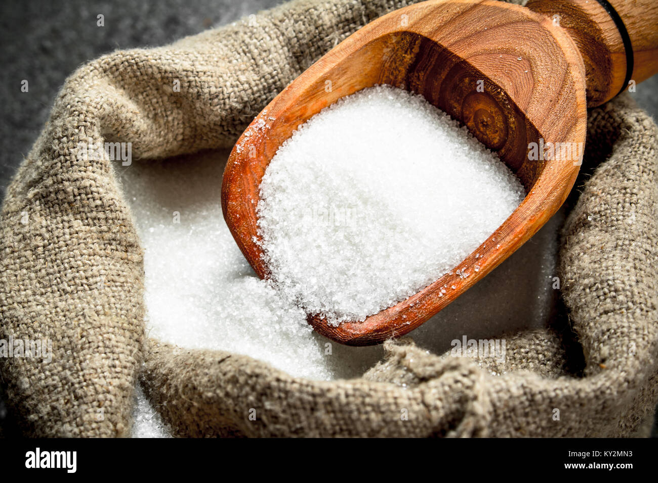 Sugar in an old sack with a scoop. On a rustic background Stock Photo ...