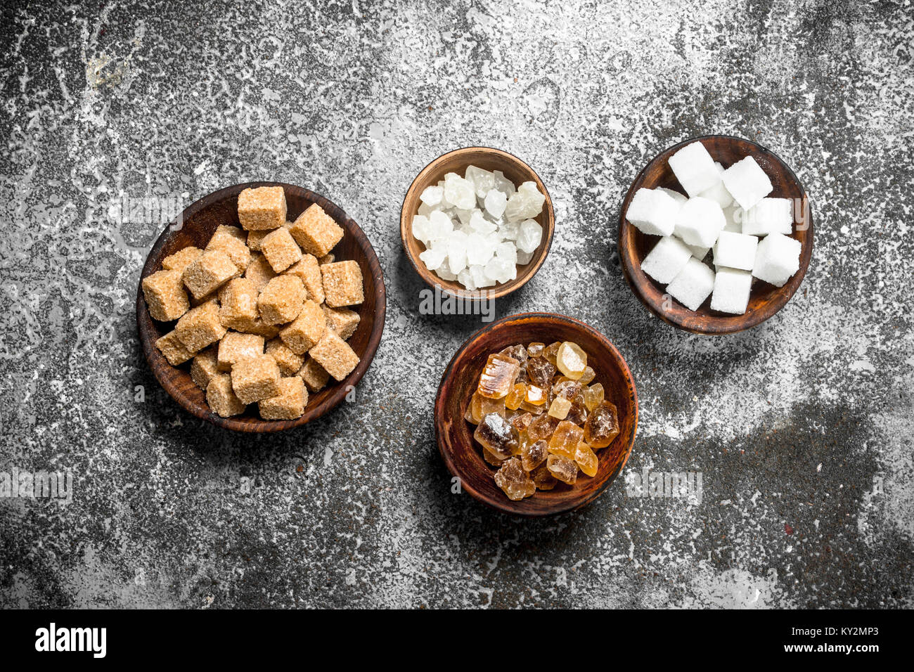 Different kinds of sugar in bowls. On a rustic background Stock Photo ...