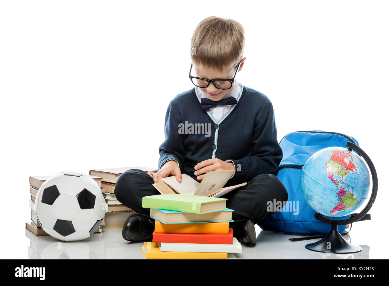 intelligent elementary school student with books on a white background ...