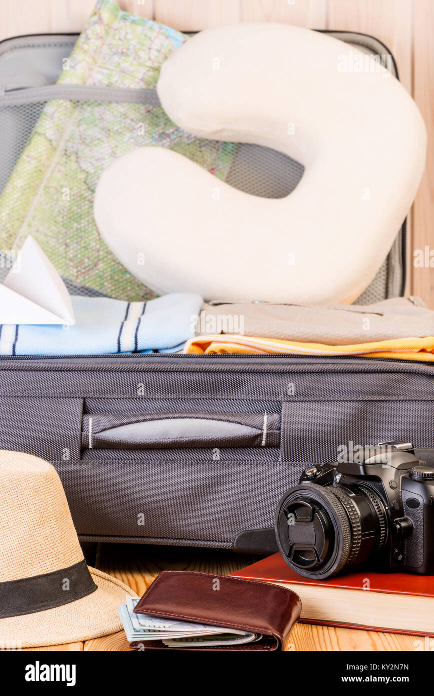 vertical photo of objects for travel near the suitcase Stock Photo - Alamy