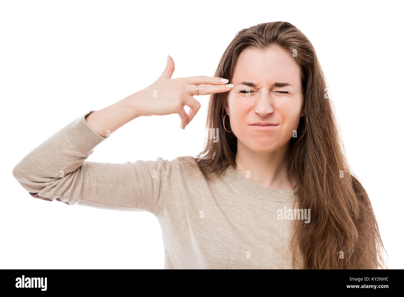 tired crazy woman with a gun gesture near the temple on a white ...