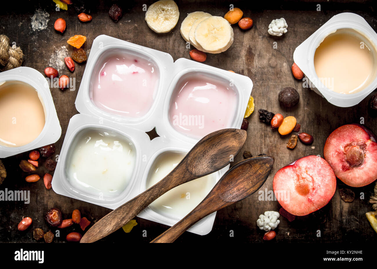 Various fruit yoghurts. On a wooden background Stock Photo - Alamy