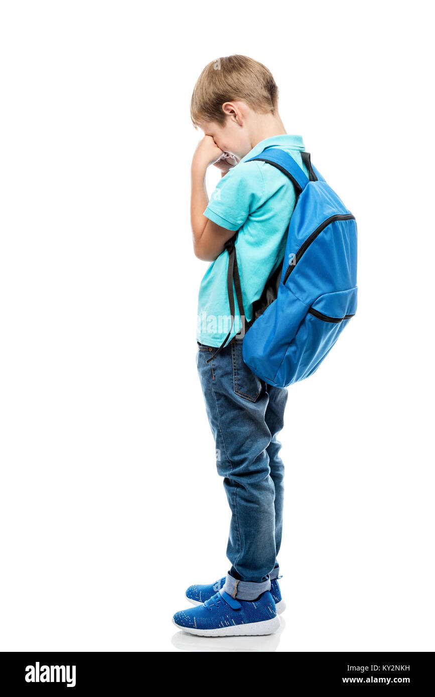 upset schoolboy with backpack crying on white background, isolated in ...