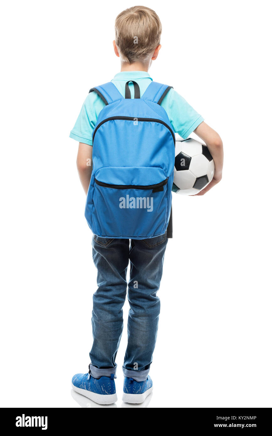 schoolboy with backpack and a football ball view from behind on a white ...