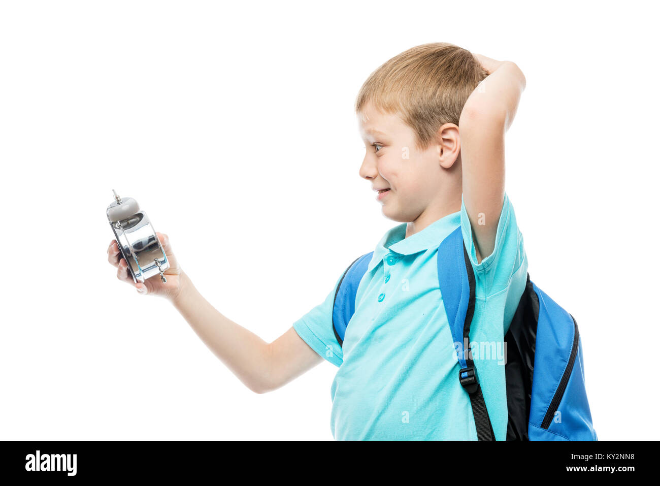 surprised schoolboy looking at alarm clock on white background Stock ...
