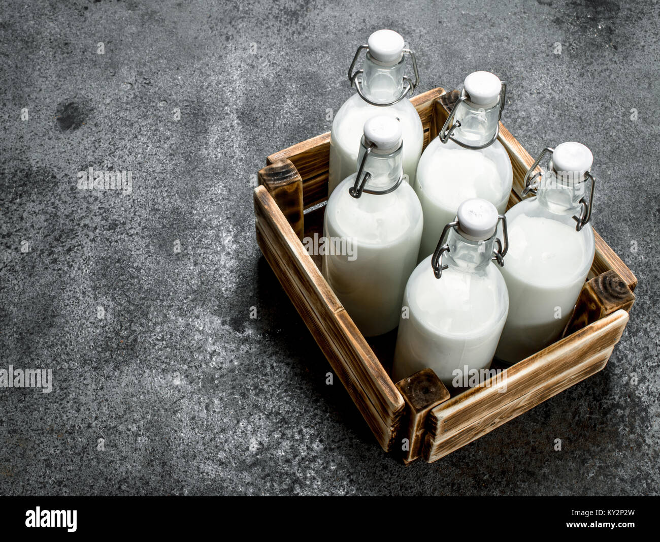 Bottles of fresh milk in an old box. On a rustic background Stock Photo ...