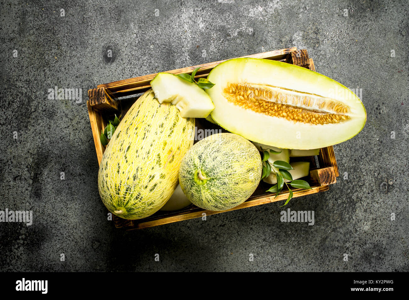 Fresh ripe sliced melon. On a rustic background Stock Photo - Alamy