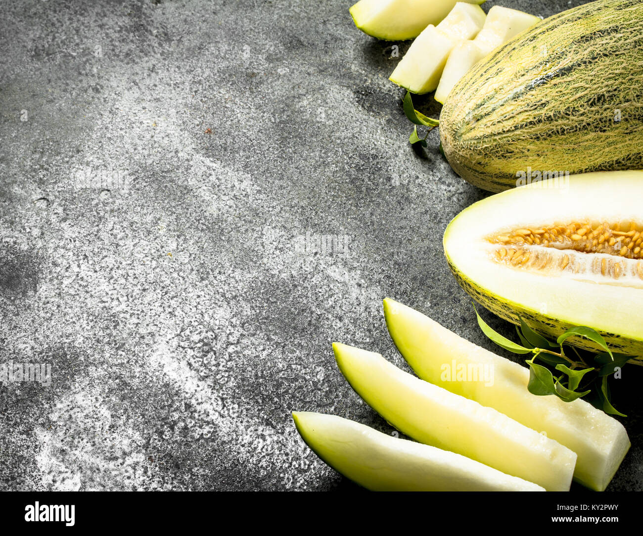 Fresh ripe sliced melon. On a rustic background Stock Photo - Alamy