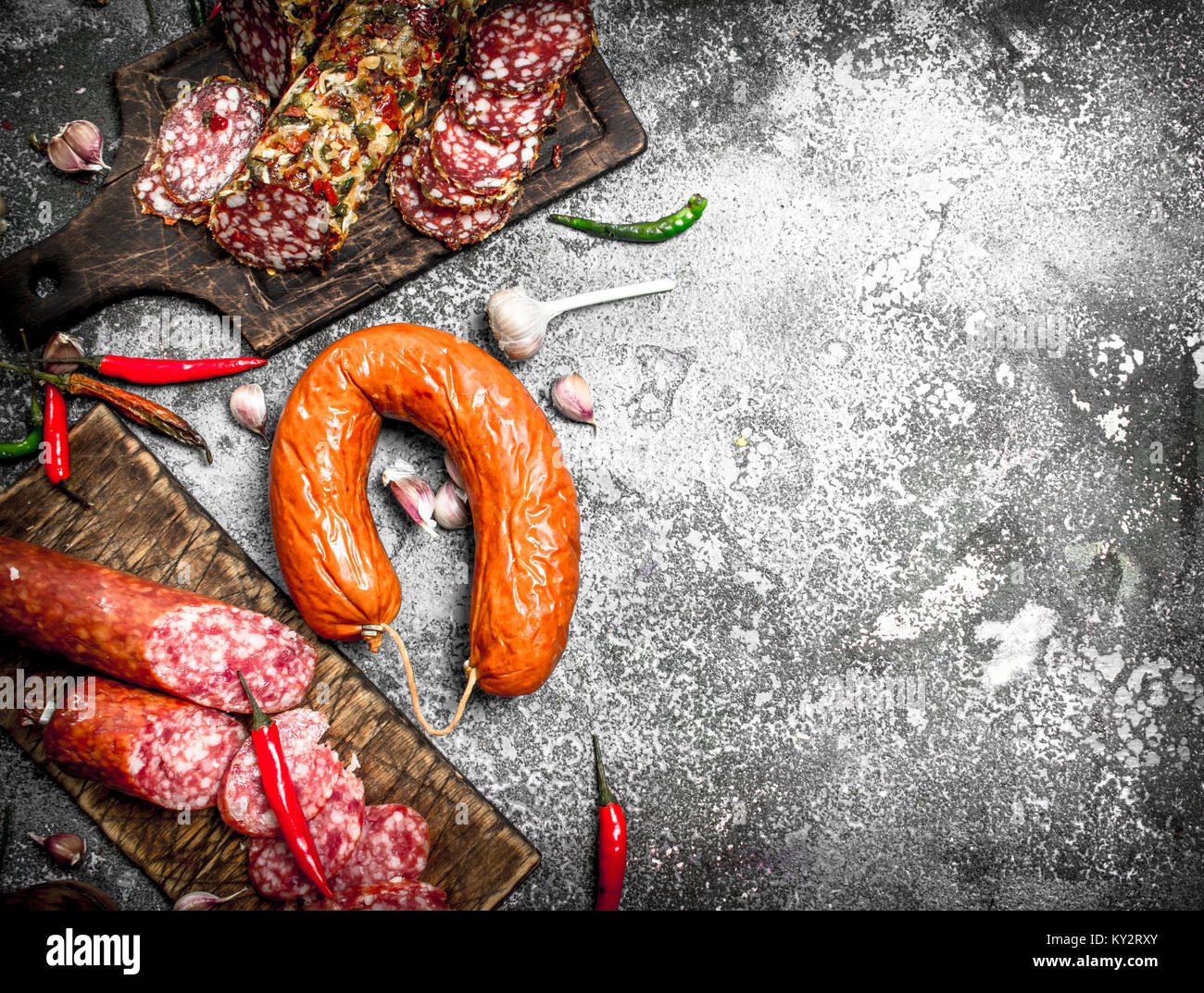 Salami background. Different kinds of salami with spices. On a rustic ...