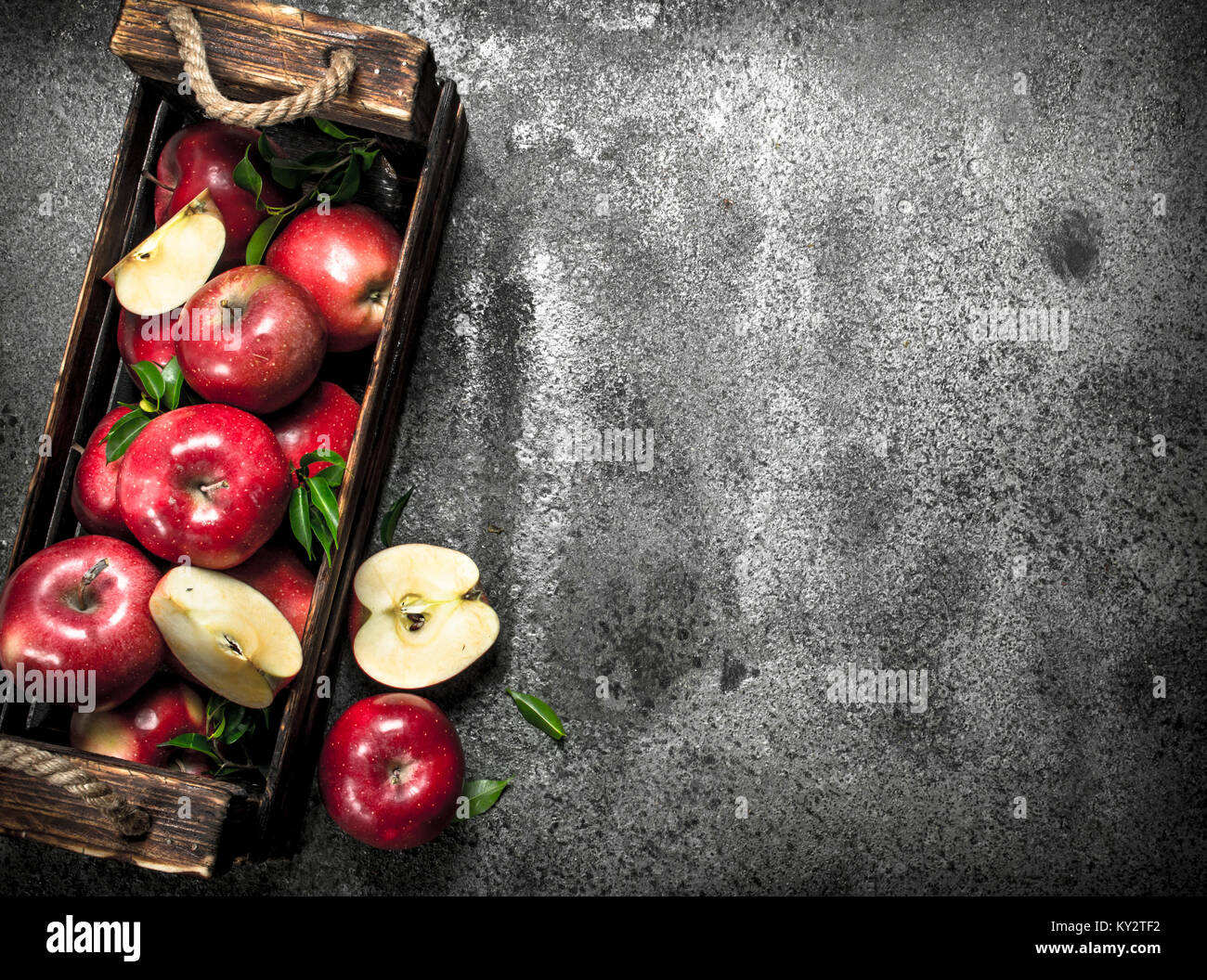 box with ripe red apples. On a rustic background Stock Photo - Alamy