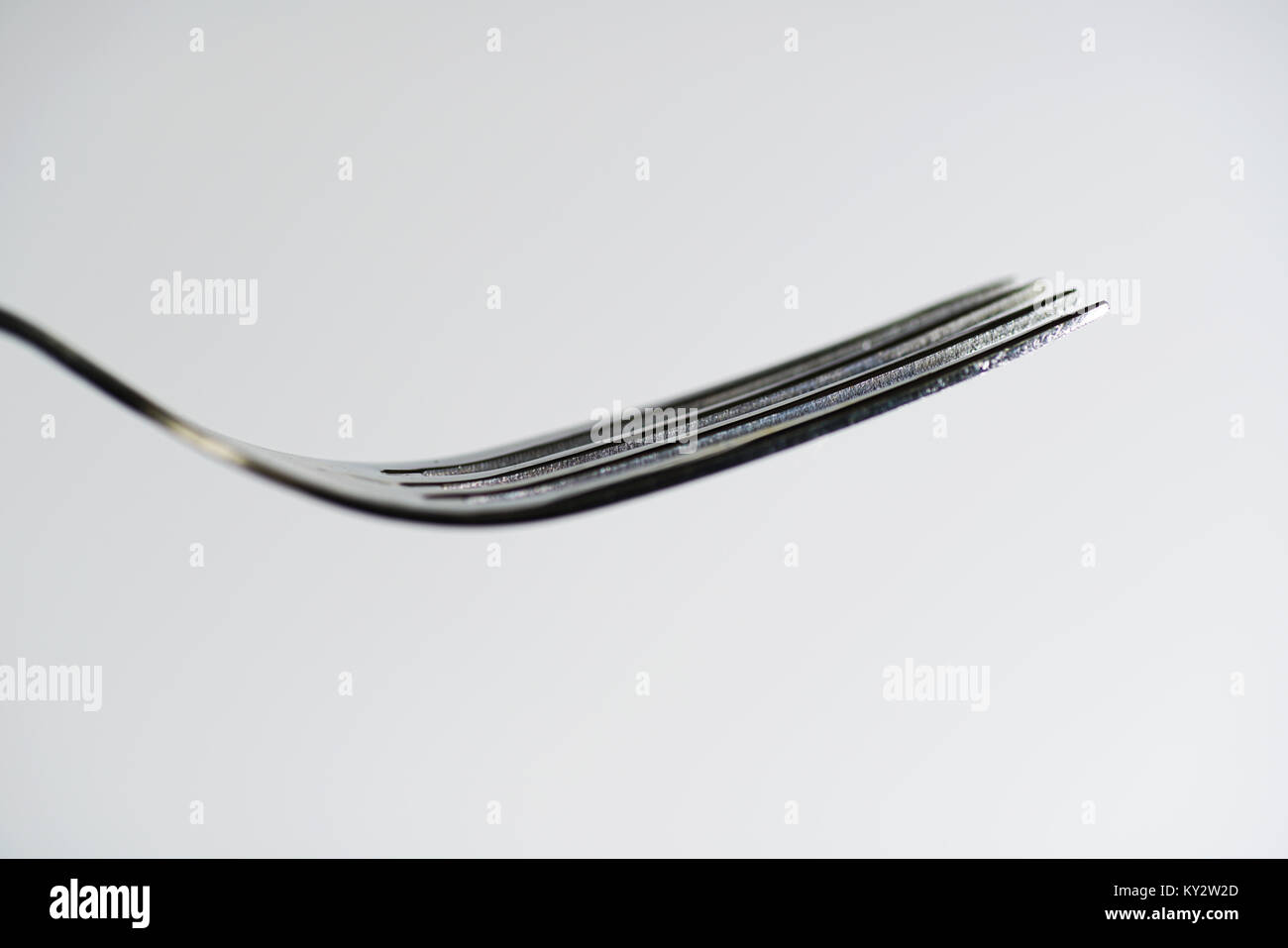Detail of a fork fork photographed in front of white background in the ...