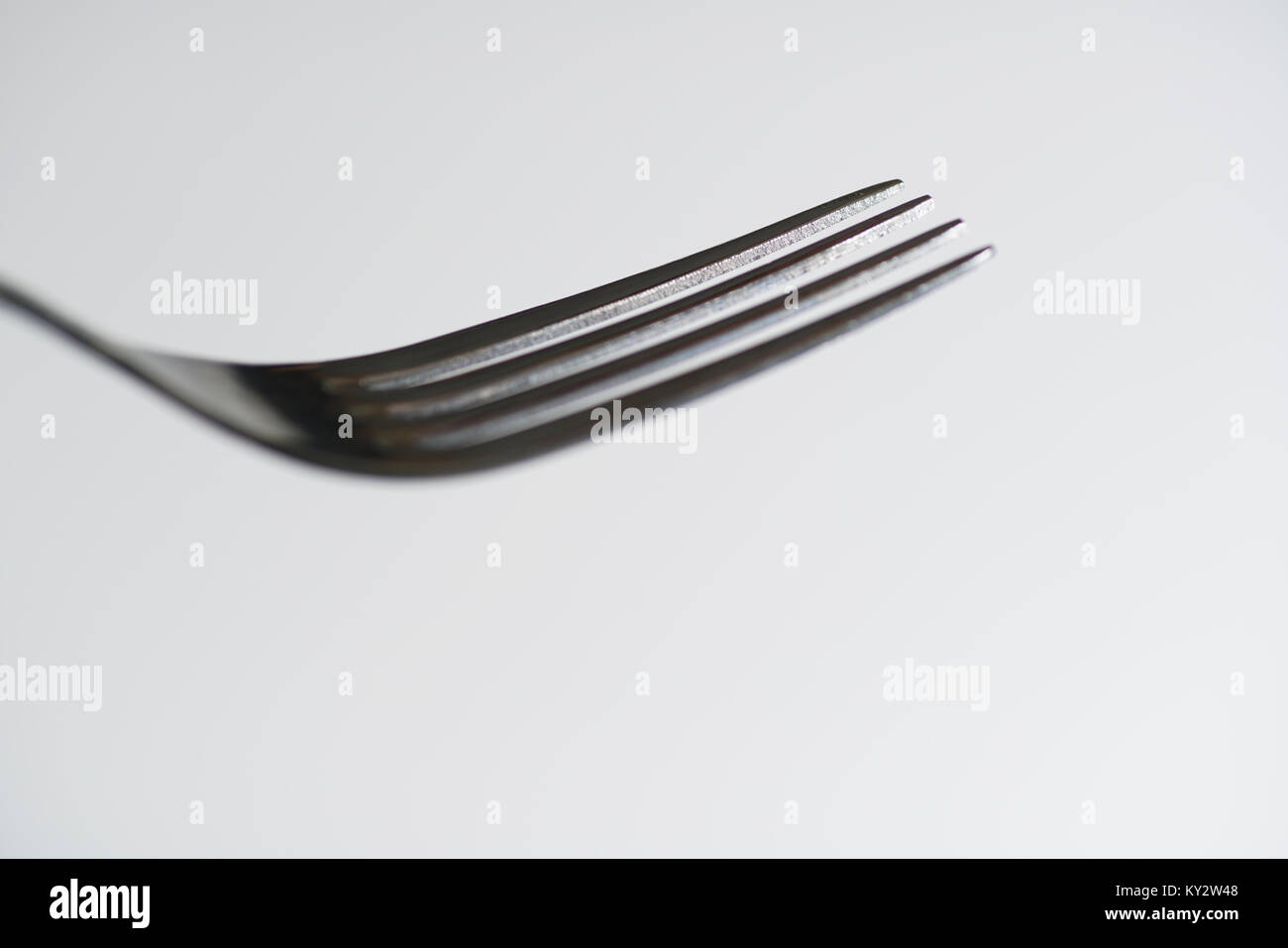 Detail of a fork fork photographed in front of white background in the ...