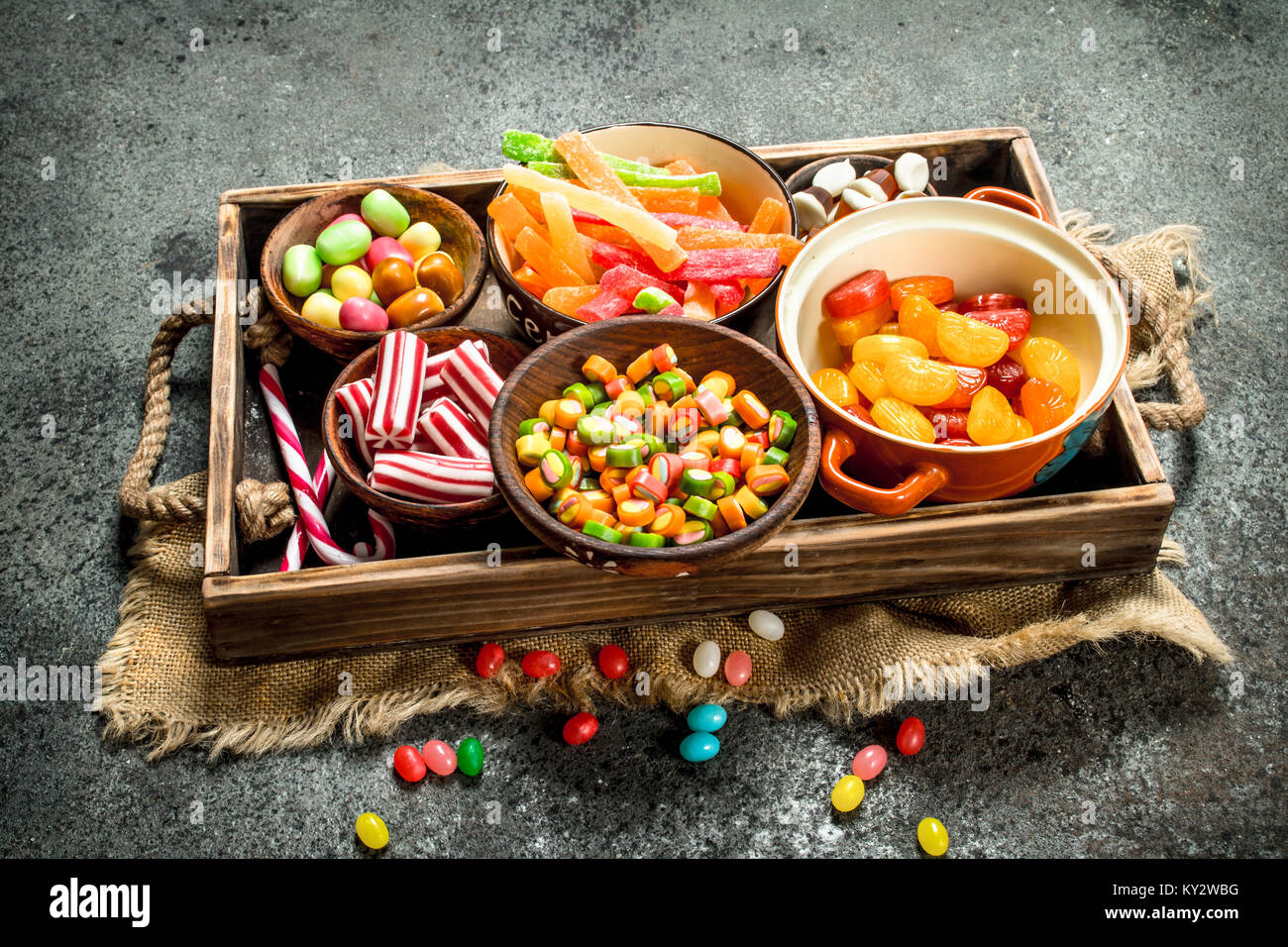 Various sweets and candied fruits. On a rustic background Stock Photo ...