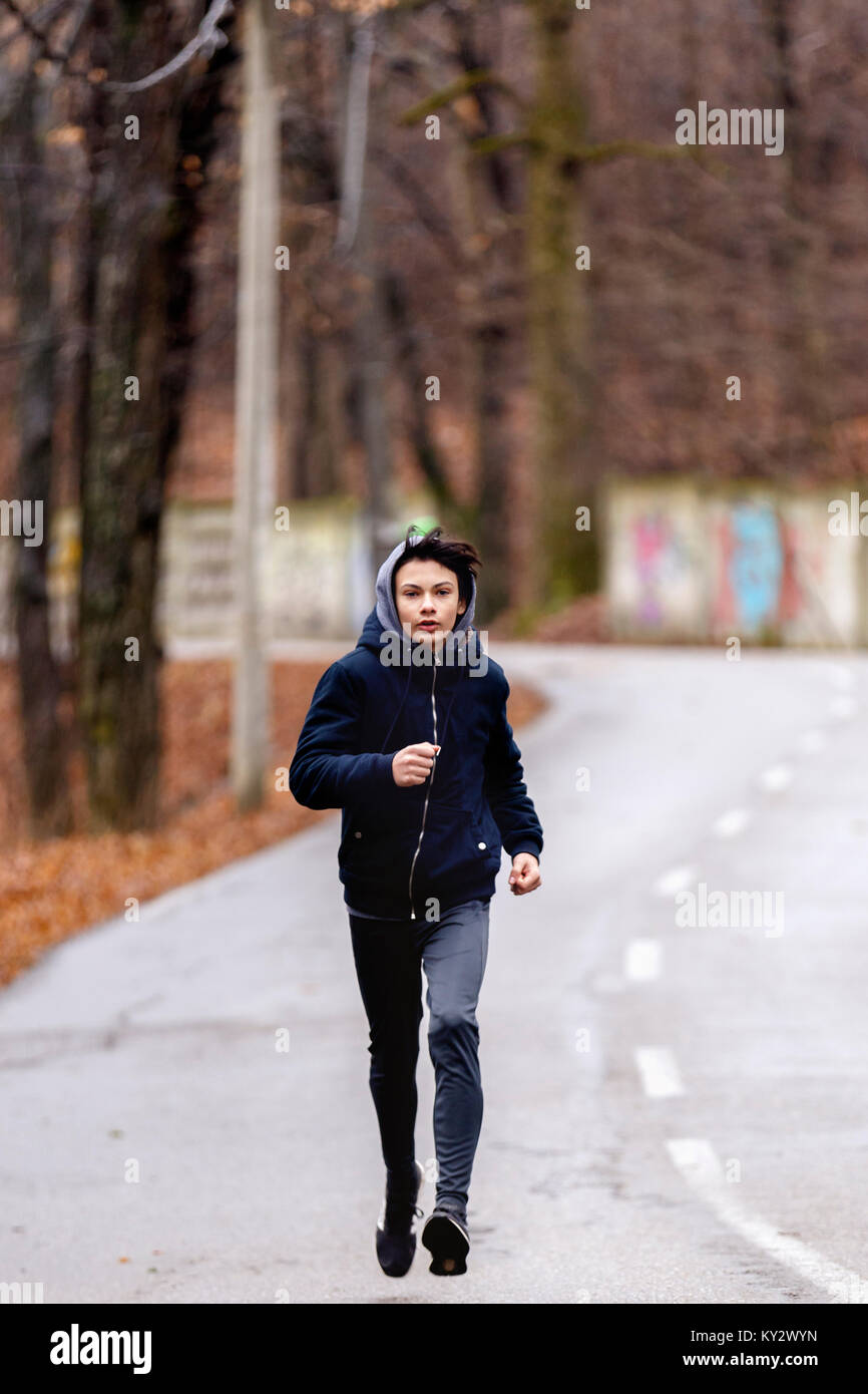 young man running in the park during the rain Stock Photo - Alamy