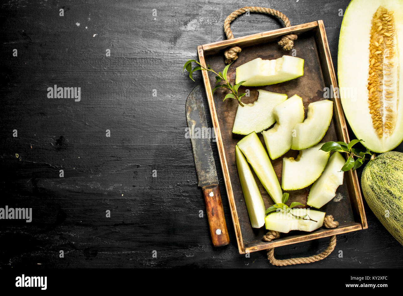 Fresh melon in a box with a hatchet. On the black chalkboard Stock ...