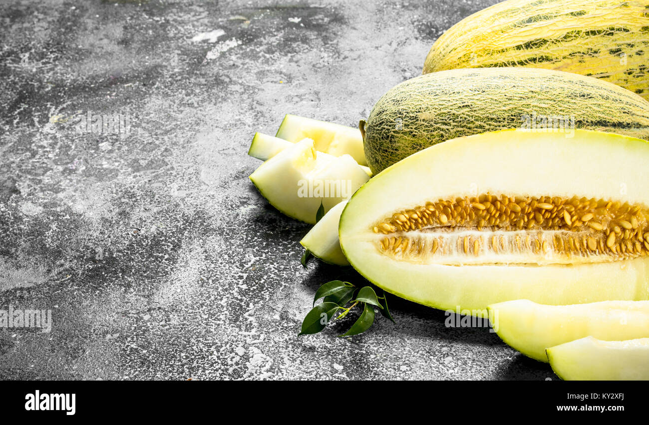 Fresh ripe sliced melon. On a rustic background Stock Photo - Alamy