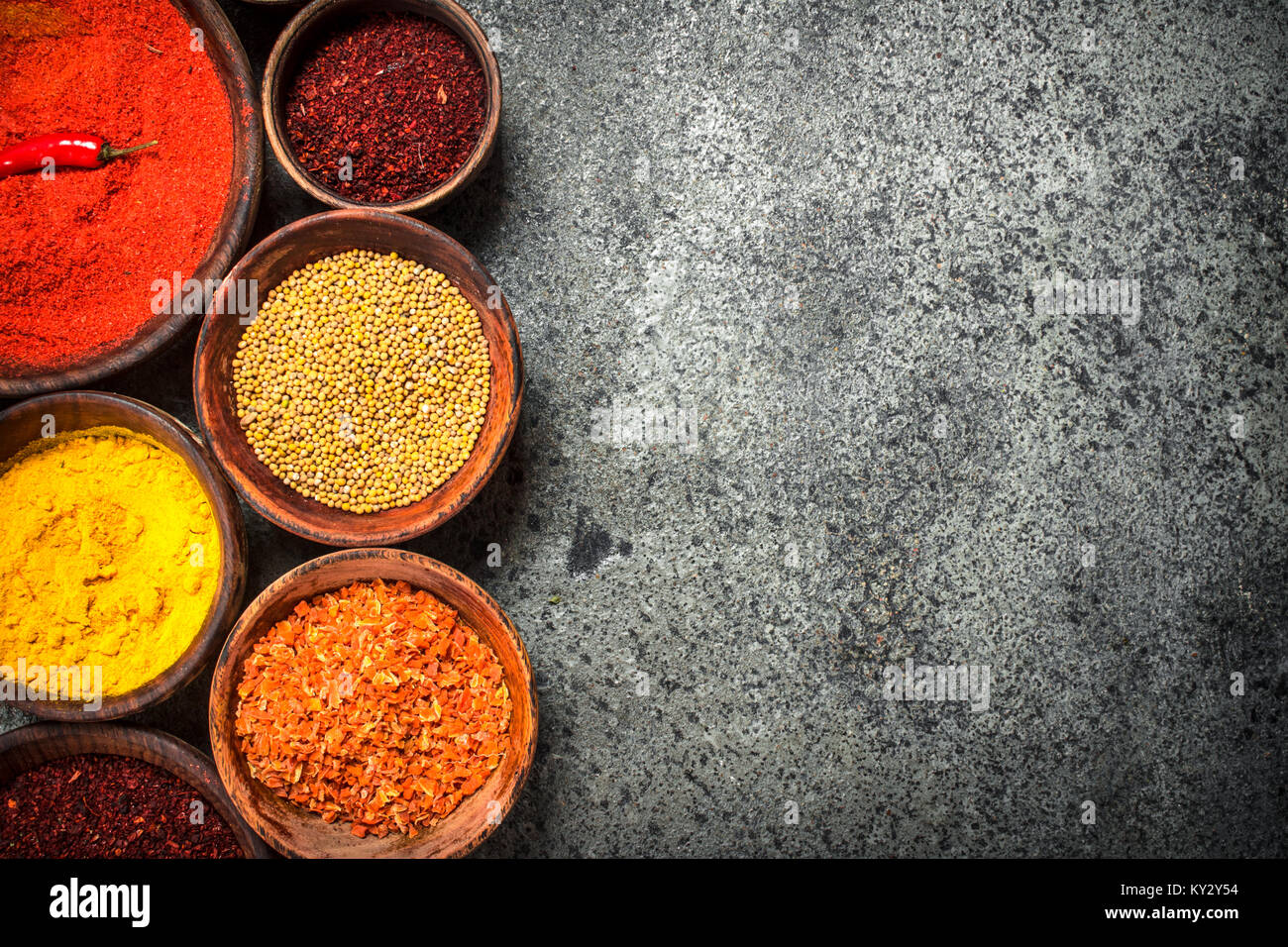 Ground spices in bowls. On a rustic background Stock Photo - Alamy