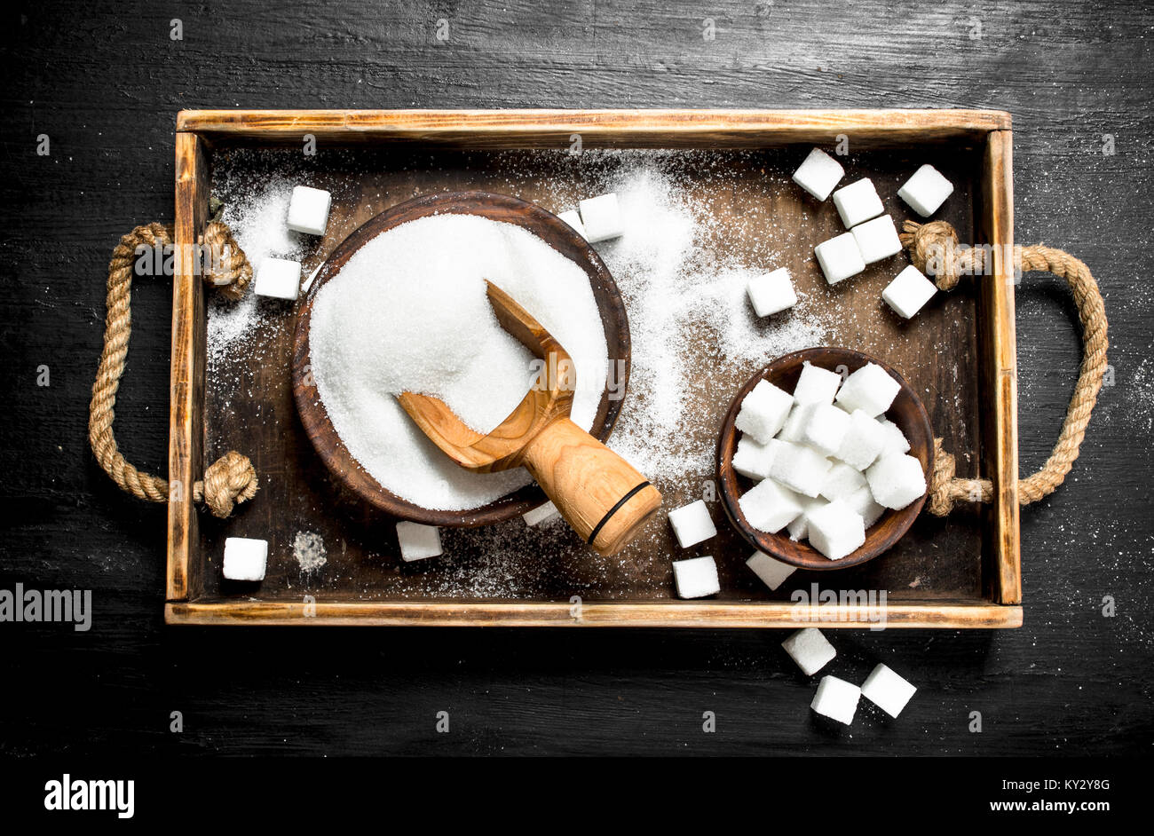Sugar on an old wooden tray. On the black chalkboard Stock Photo - Alamy