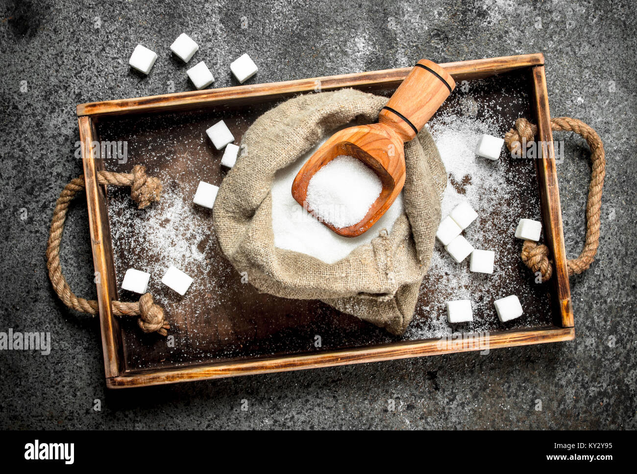 Sugar in an old sack with a scoop. On a rustic background Stock Photo ...
