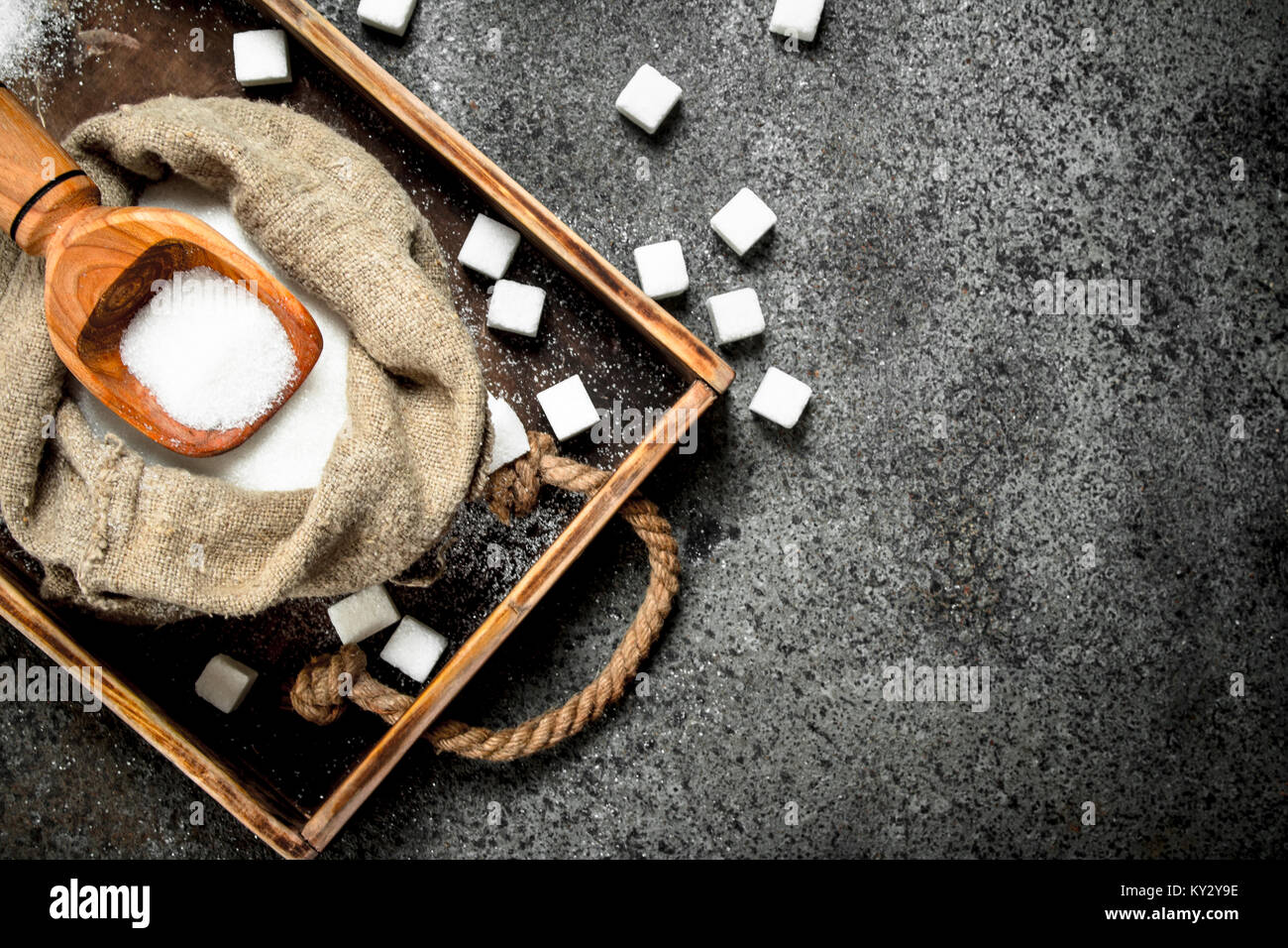 Sugar in an old sack with a scoop. On a rustic background Stock Photo ...
