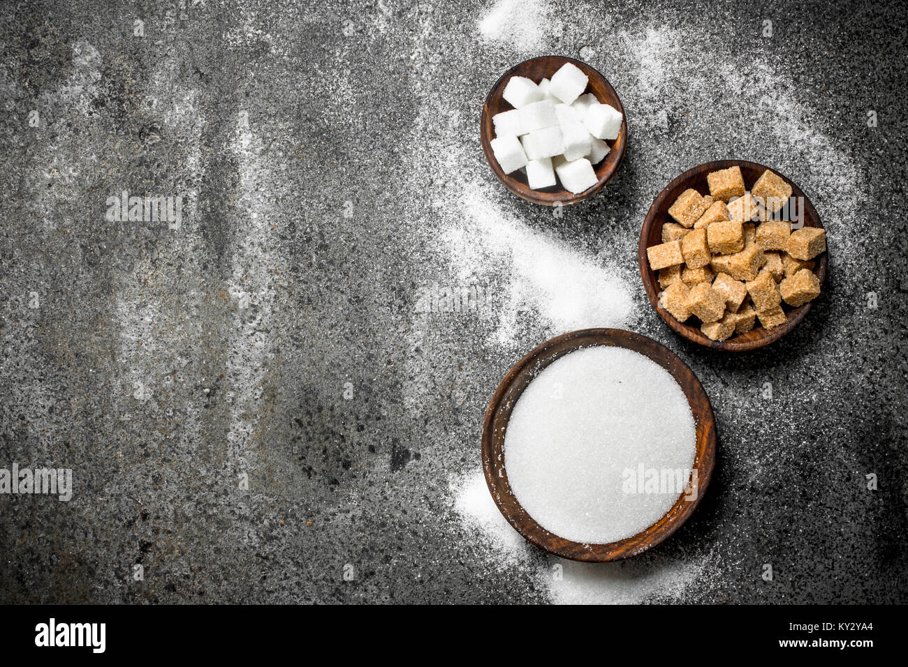 Different kinds of sugar in bowls. On a rustic background Stock Photo ...