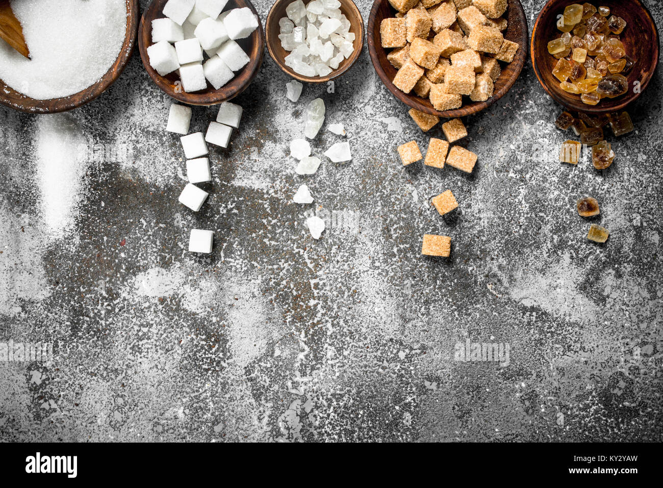 Different kinds of sugar in bowls. On a rustic background Stock Photo ...