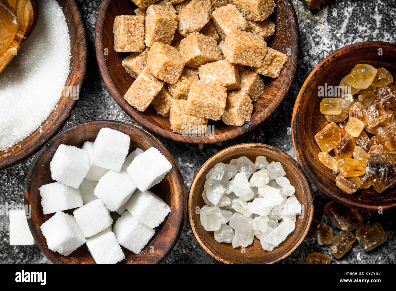 Different kinds of sugar in bowls. On a rustic background Stock Photo ...