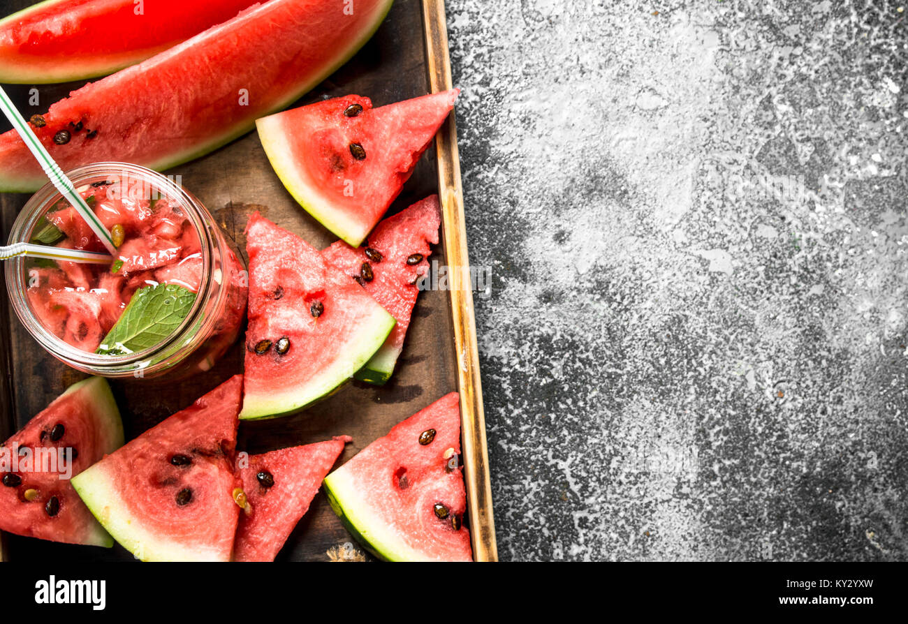 Watermelon cocktail on a wooden tray. On a rustic background Stock ...
