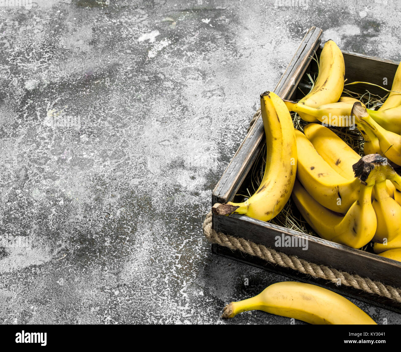 Fresh bananas in an old box. On a rustic background Stock Photo - Alamy