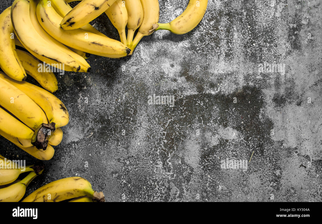 Fresh bunches of bananas. On a rustic background Stock Photo - Alamy