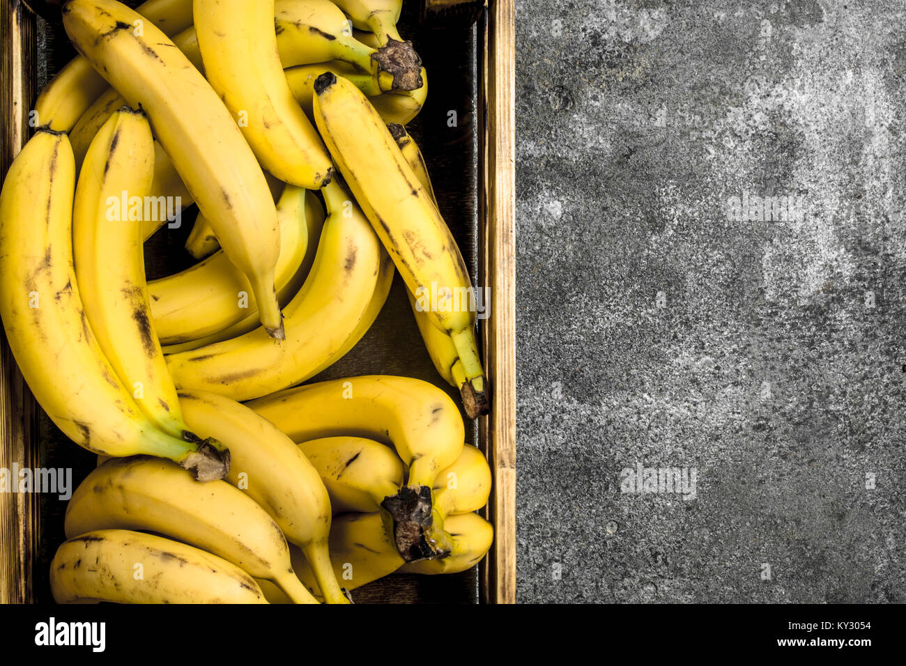 Fresh bananas in an old box. On a rustic background Stock Photo - Alamy