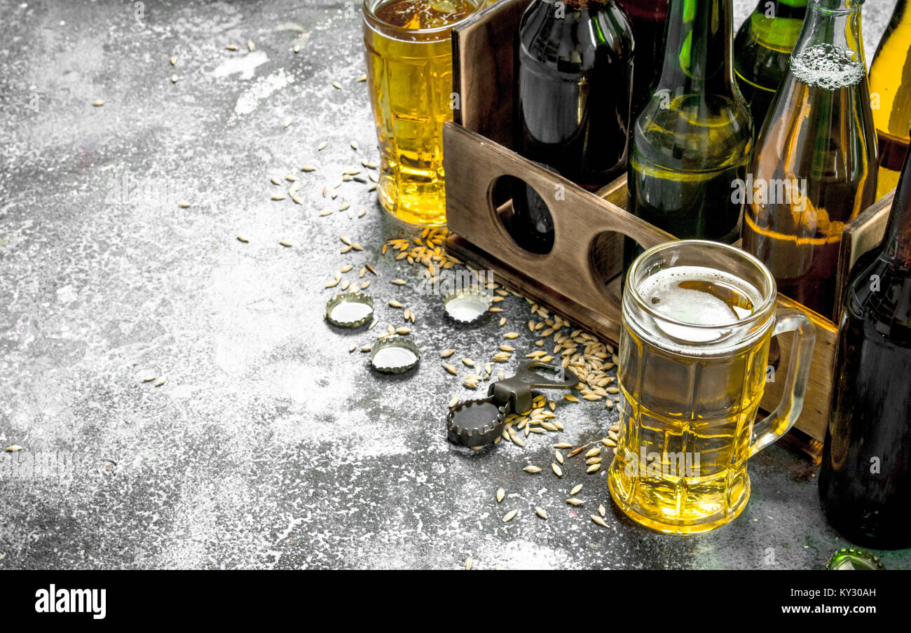 Beer background. Fresh beer in glasses and an old box. On a rustic ...