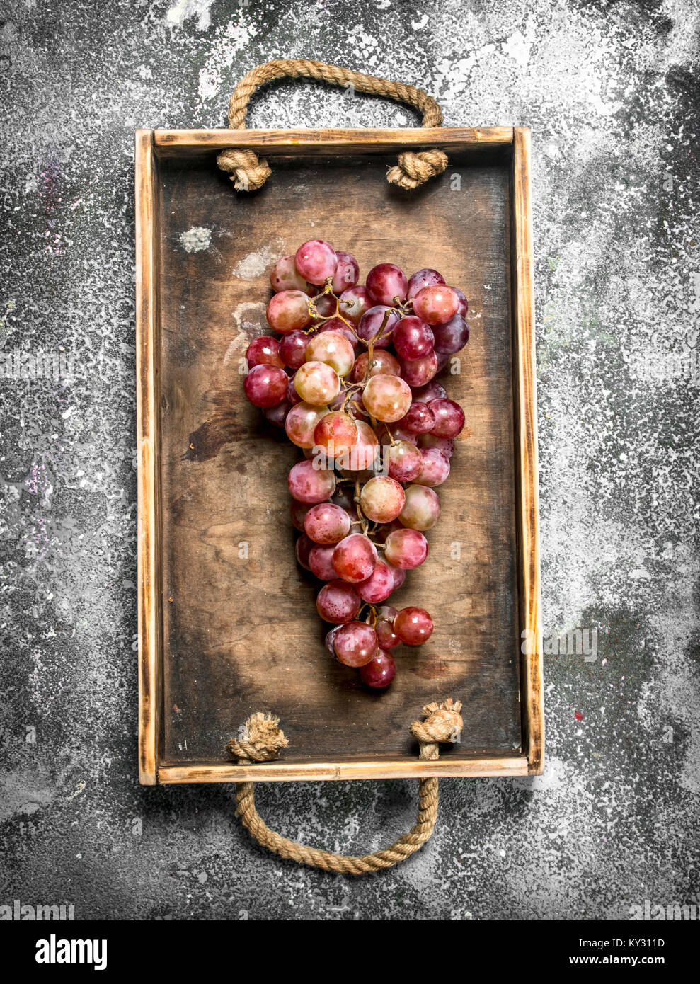 bunch of red grapes on a wooden tray. On a rustic background Stock ...