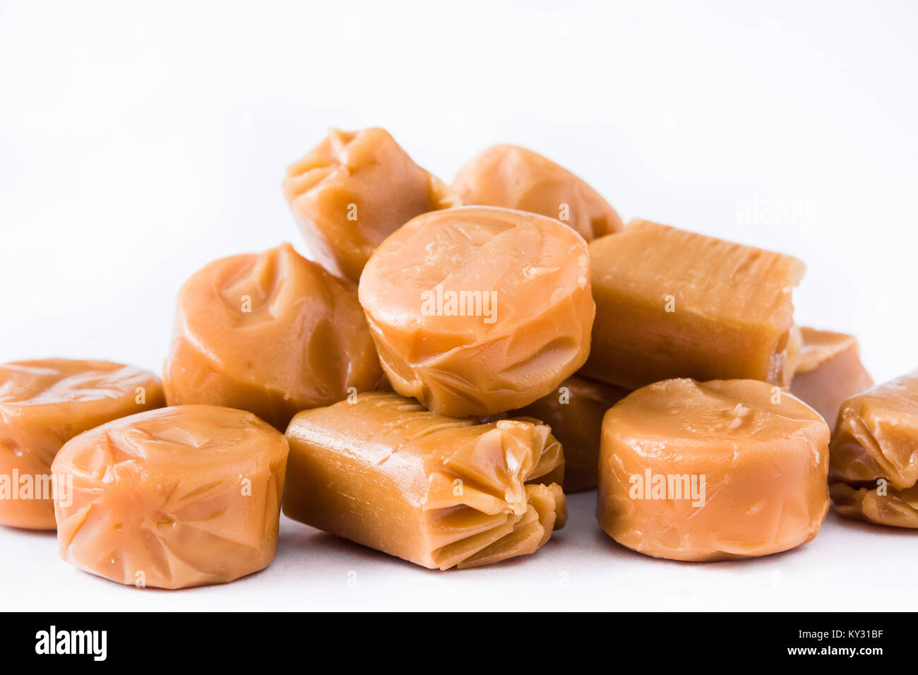 Toffee caramel candies isolated on white background Stock Photo - Alamy