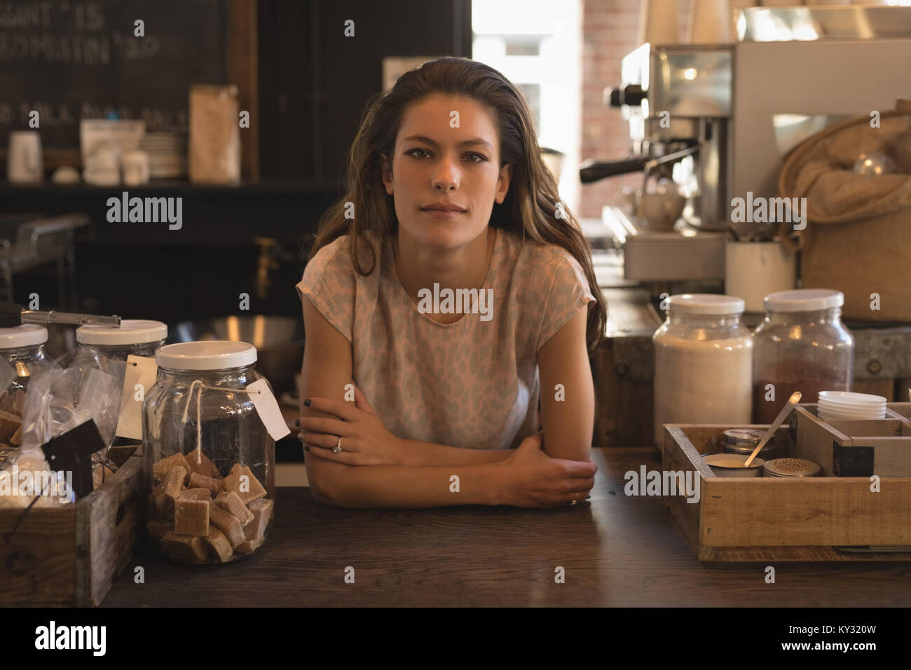 Waitress standing at counter in the coffee shop Stock Photo - Alamy