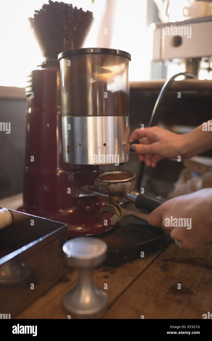Barista grinding coffee beans Stock Photo - Alamy