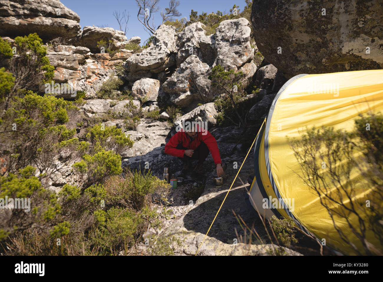 Hiker preparing drink during break on mountain Stock Photo - Alamy