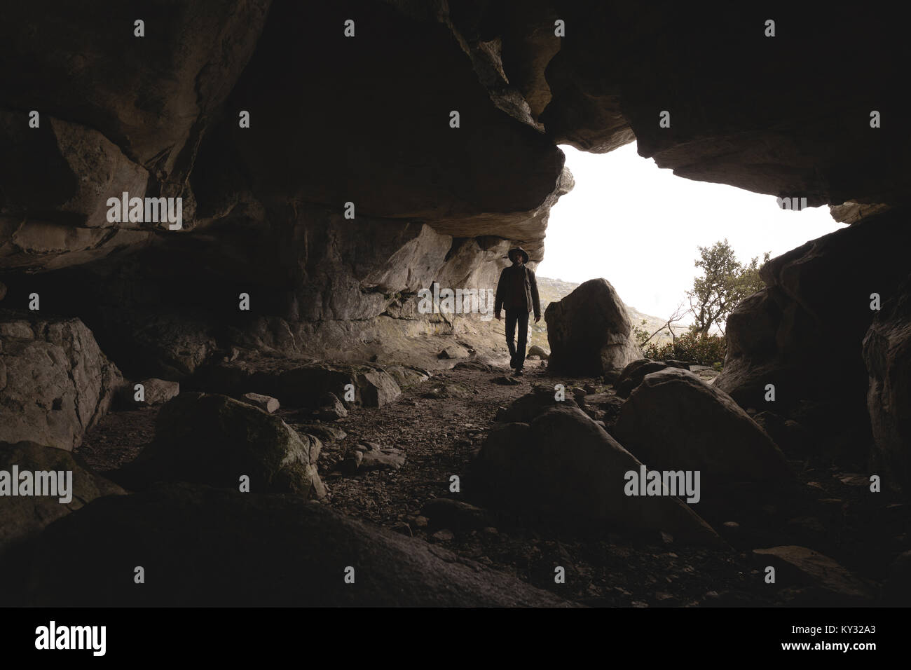 Hiker entering inside the cave Stock Photo - Alamy