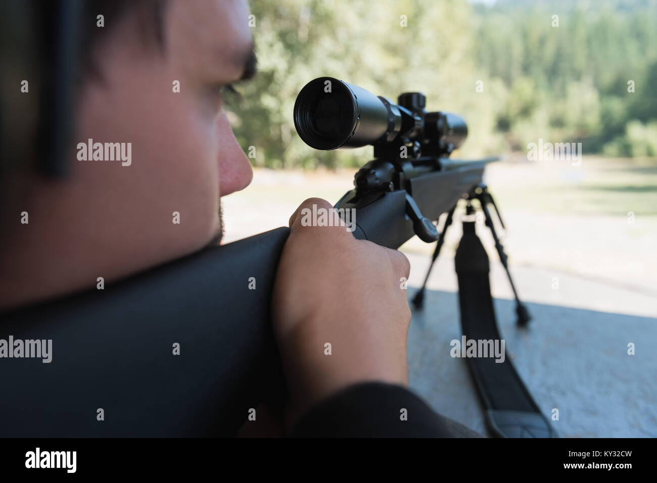 Man aiming rifle at firing range Stock Photo - Alamy