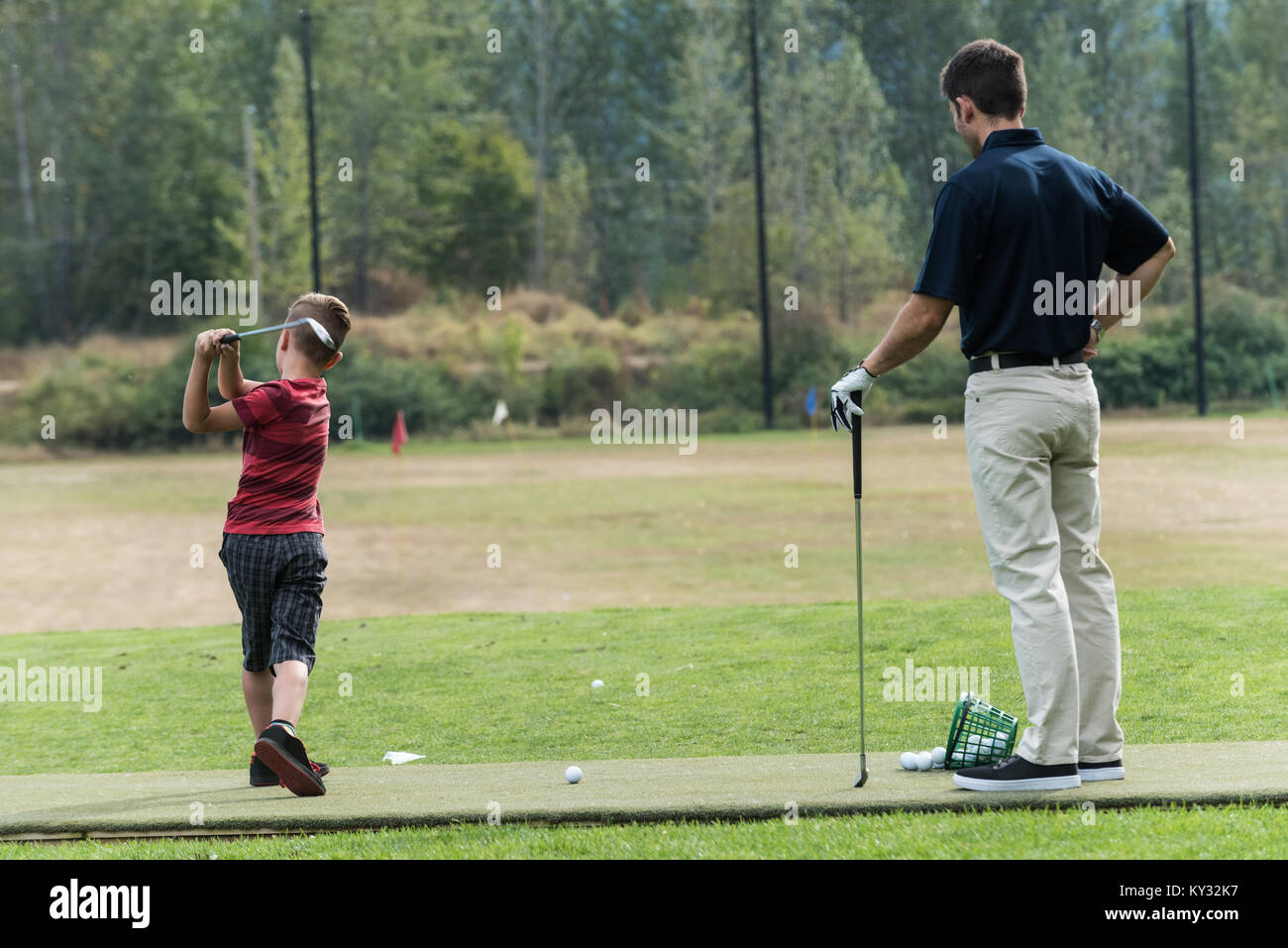 Father and son playing golf Stock Photo - Alamy