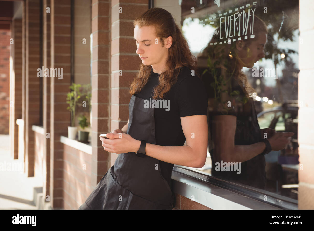 Owner using mobile phone Stock Photo - Alamy