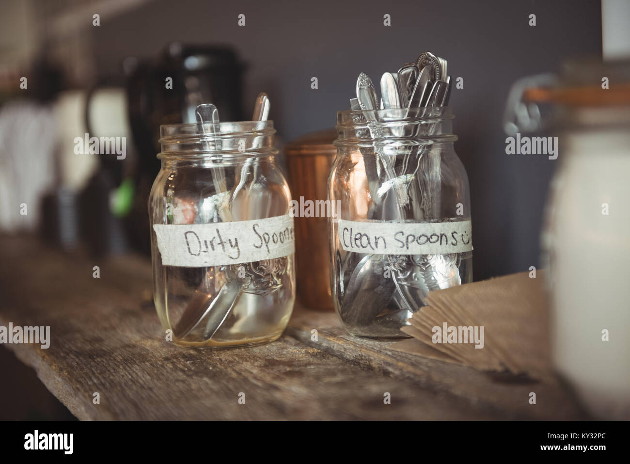 Clean and dirty spoons in jar Stock Photo - Alamy