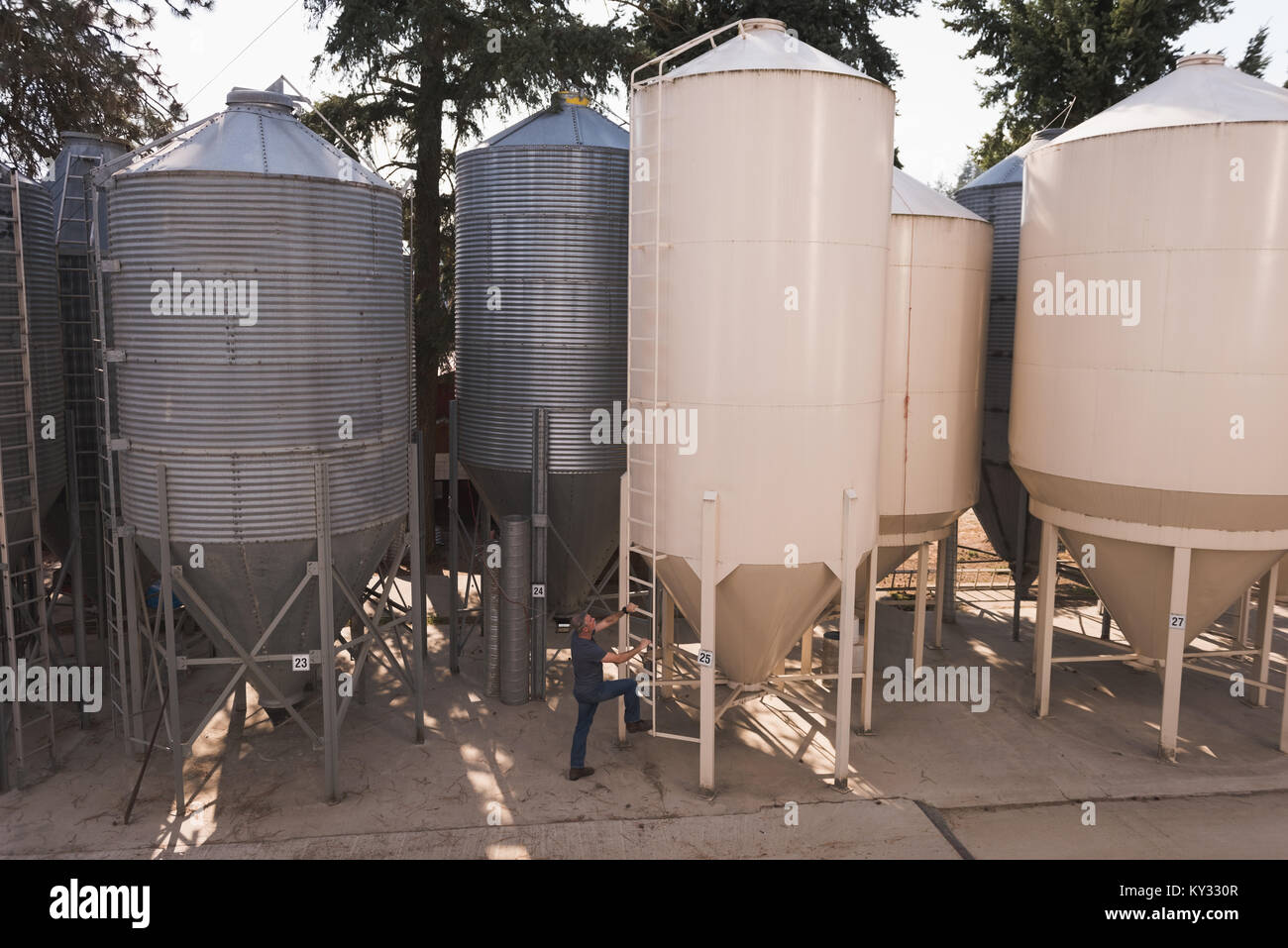 Man climbing ladder of grain elevator Stock Photo - Alamy