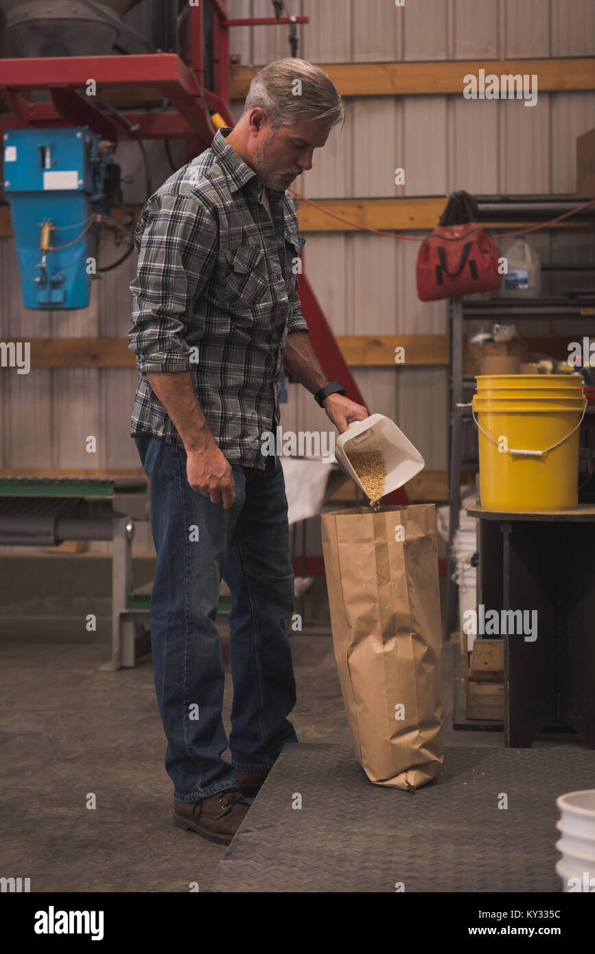 Man packing refined grains Stock Photo - Alamy