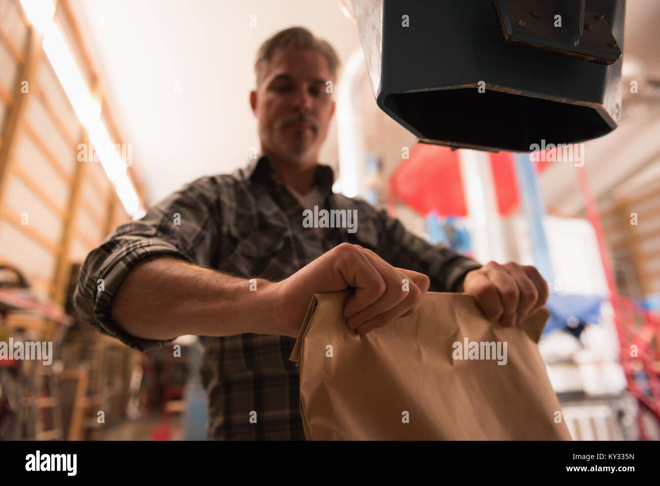 Man packing refined grains Stock Photo - Alamy