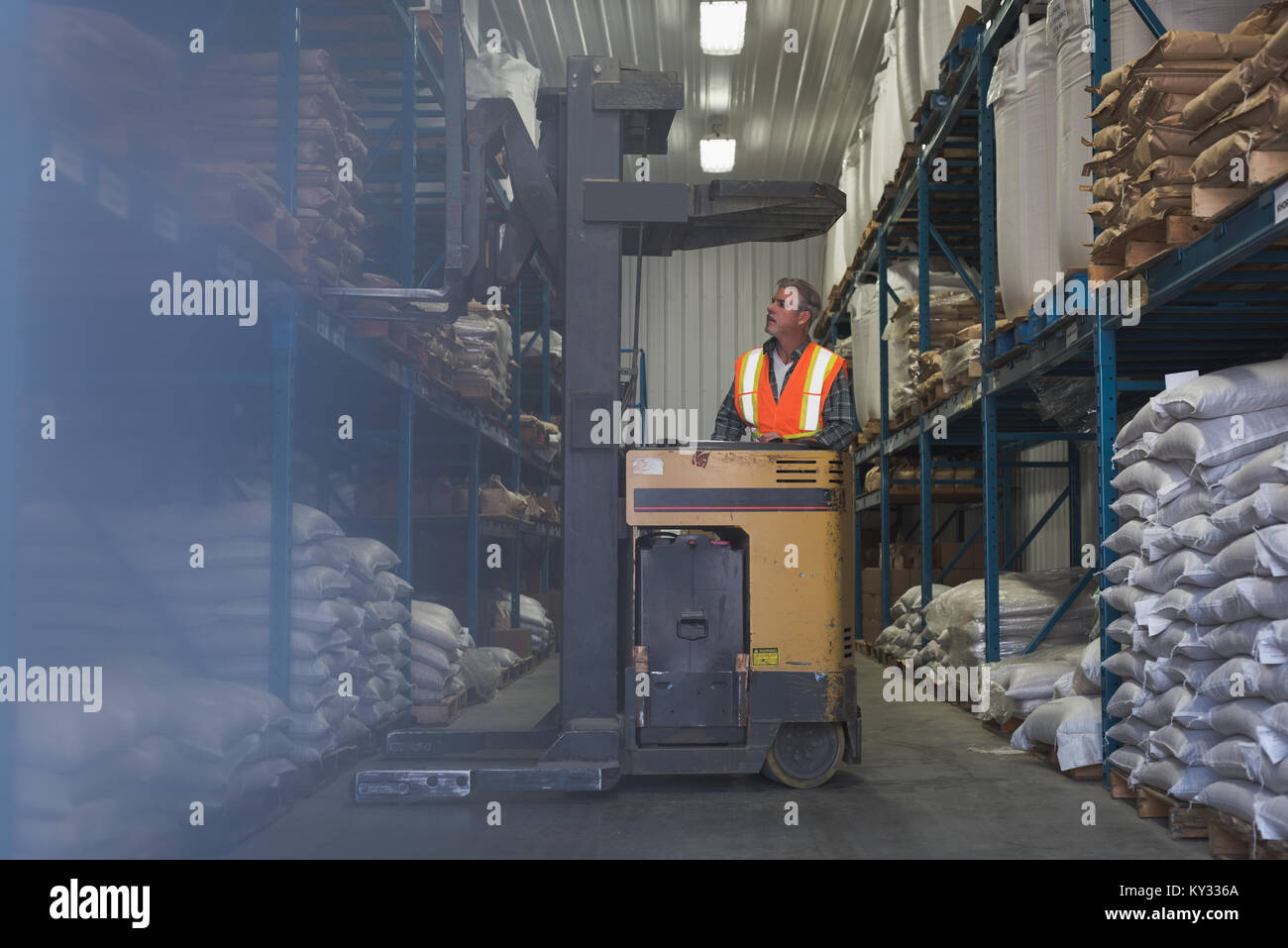Man lifting sack of grains with forklift Stock Photo - Alamy